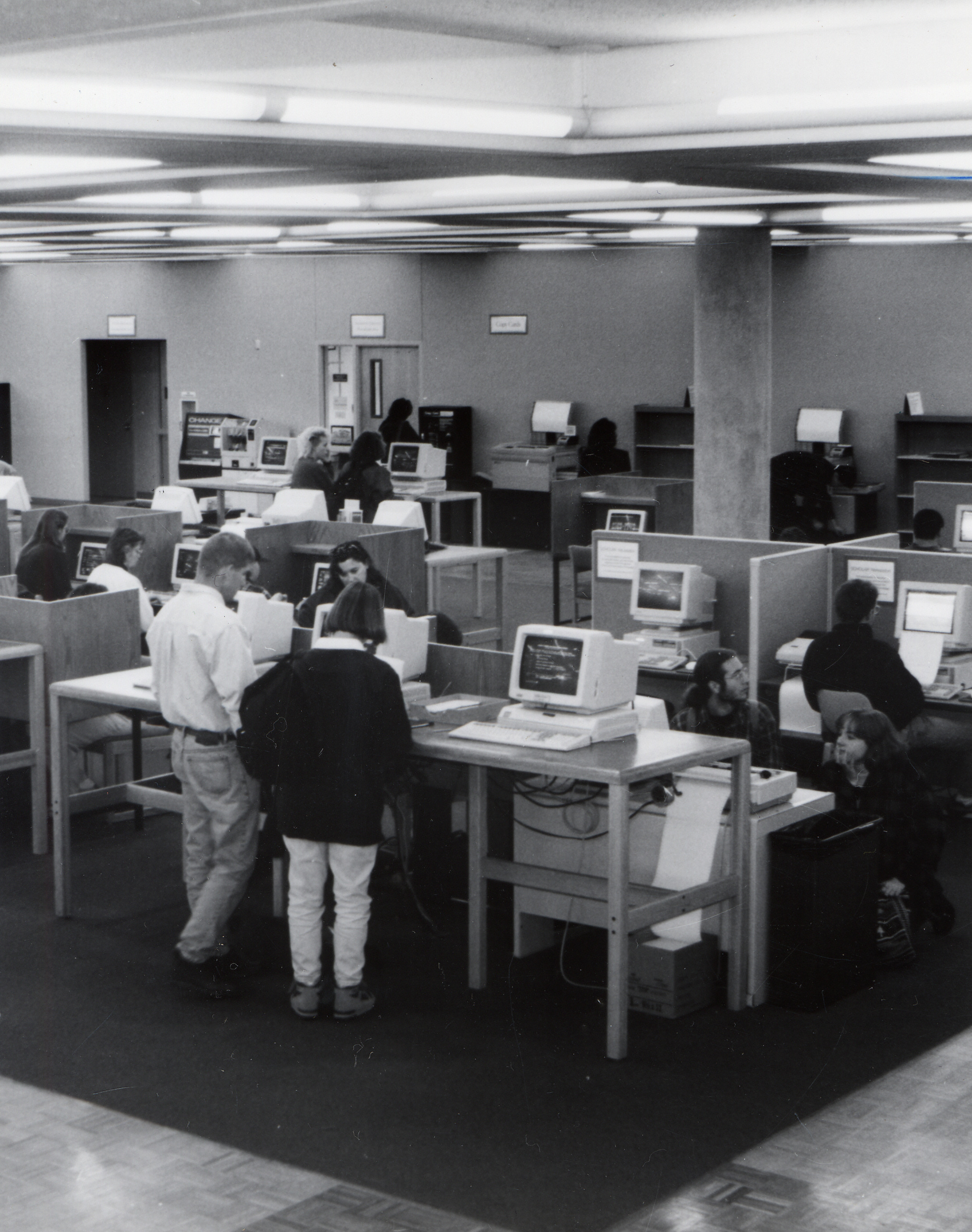 Students using computer stations near the circulation desk | Iowa State ...