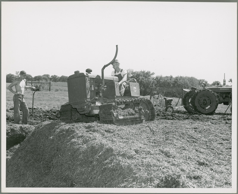 Compacting grass silage with "cat" tractor in pit silo | Iowa State ...